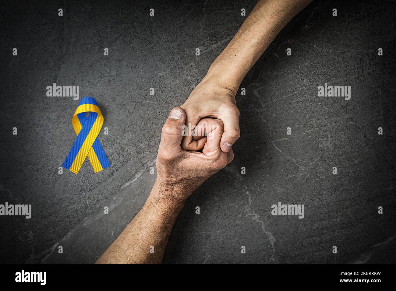 adult hand holds childs hand tightly Stock Photo - Alamy