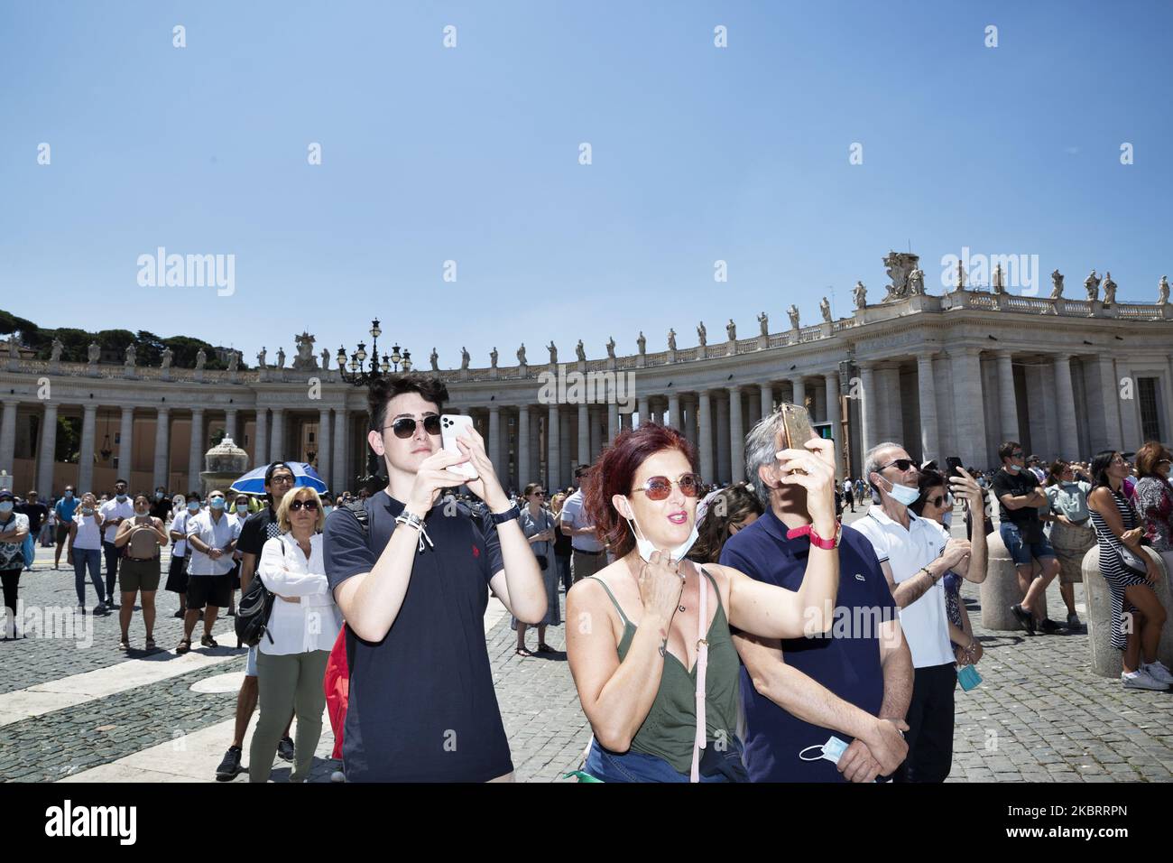 A group of belivers take pictures during the Pope Francis sunday ...