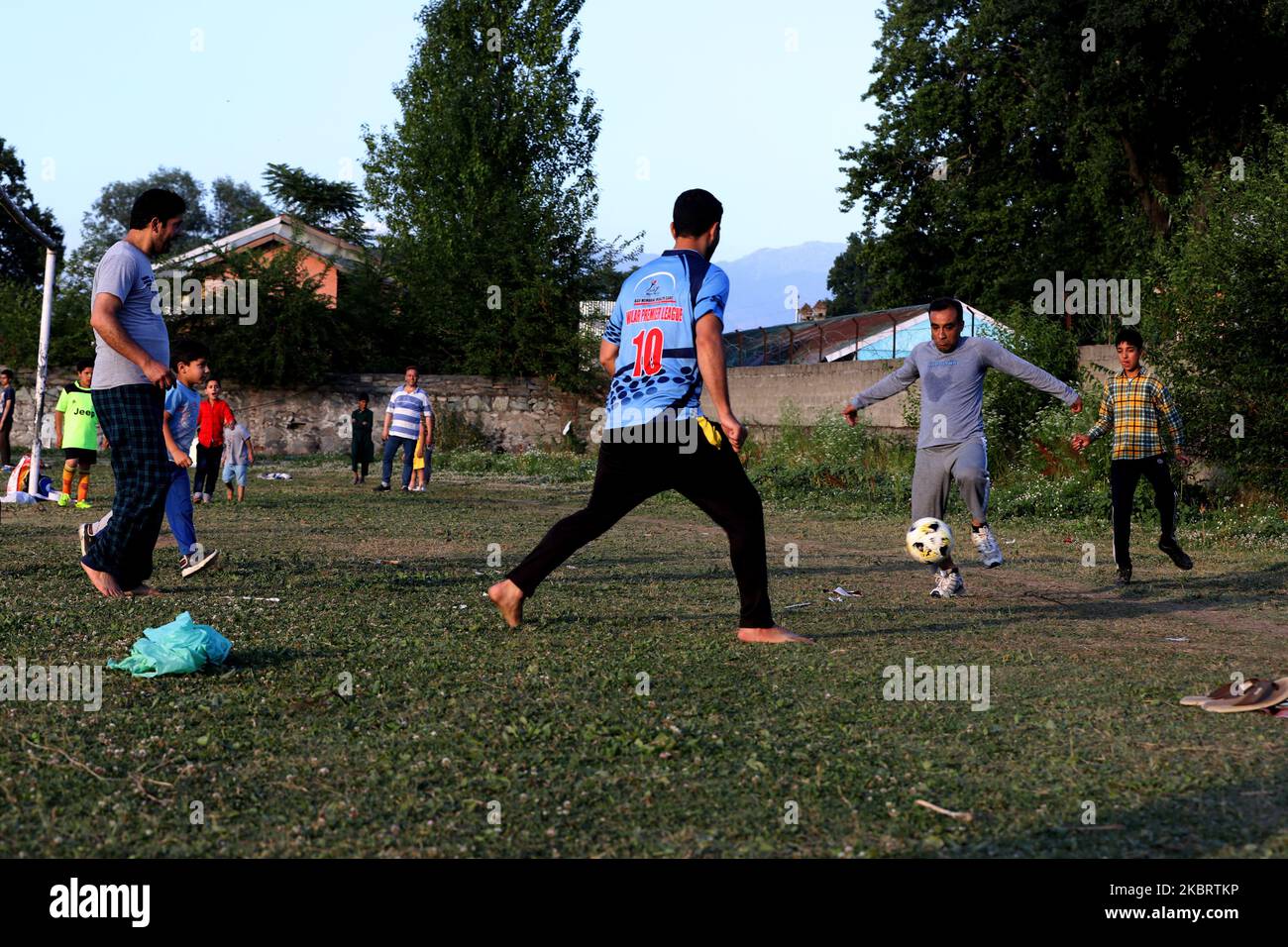 Kashmiri boys play football at a ground in Sopore town of district ...