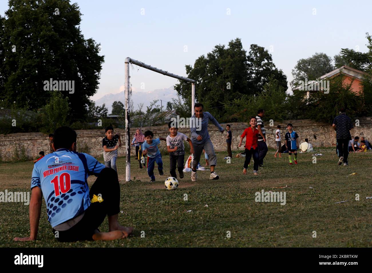 Kashmiri boys play football at a ground in Sopore town of district ...