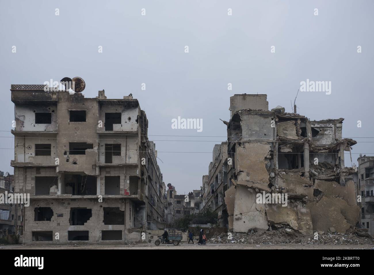 Families between the damaged buildings in Al-Mliha rural of Damascus on ...