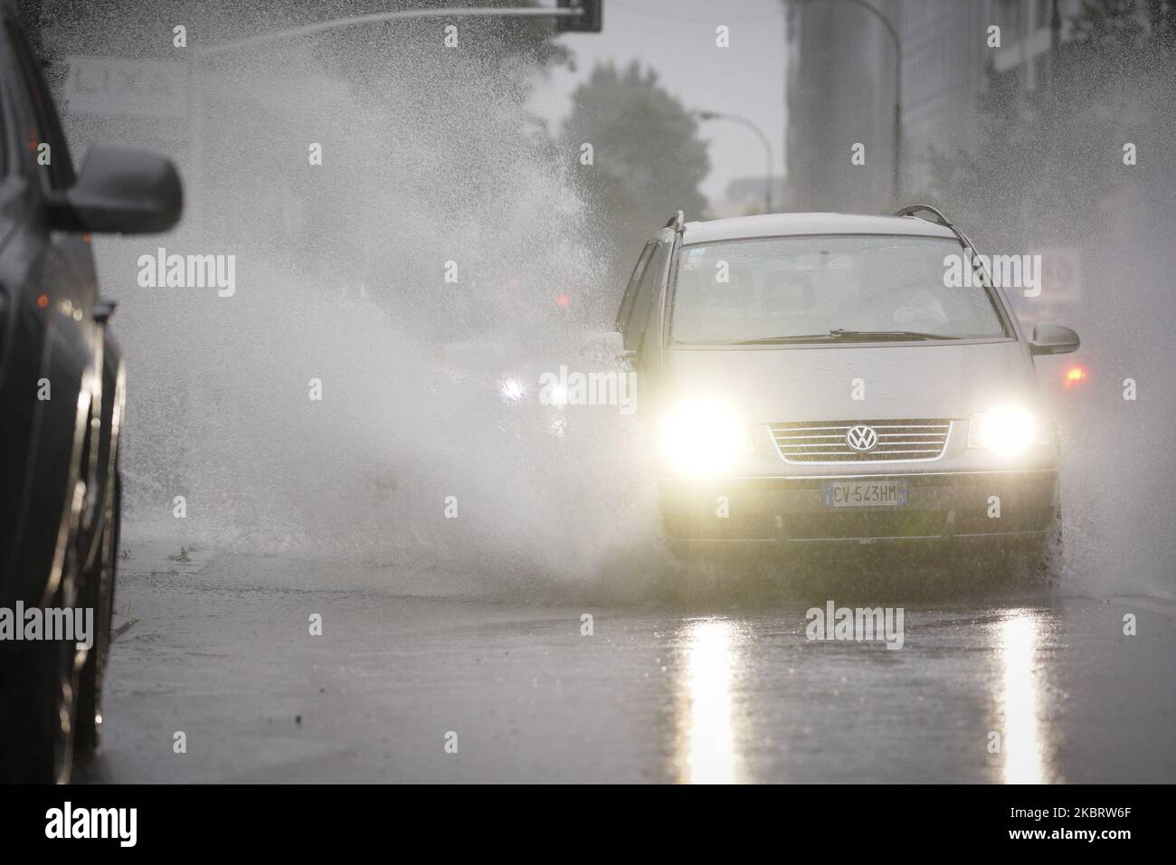 A car drives through a puddle or rain water on June 29, 2020 in Warsaw ...