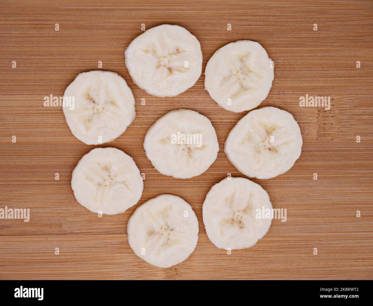 Place individual banana slices in a circle on a bamboo board Stock ...