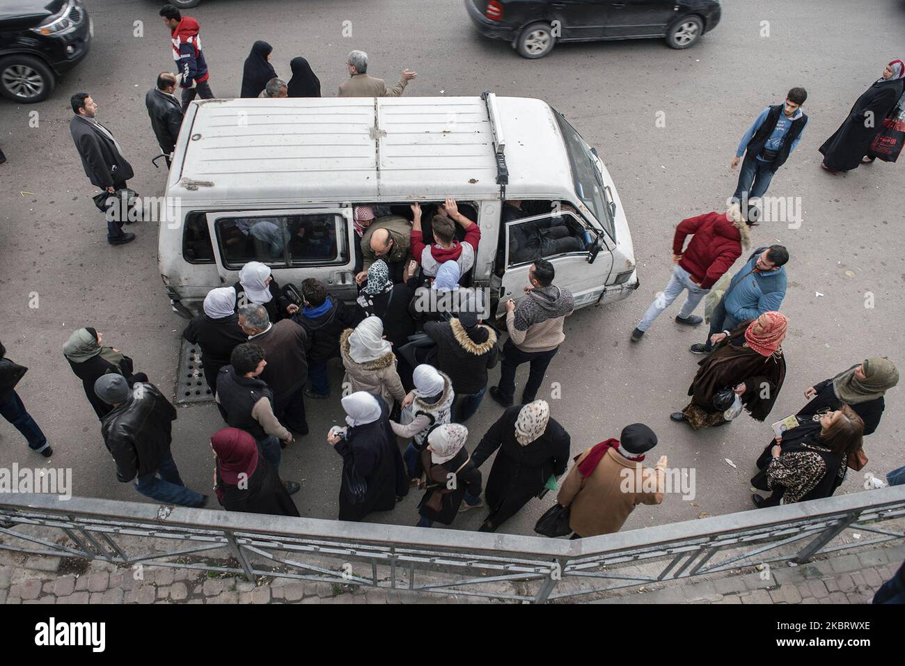 A group of people Wrestling to get a seat in the public transportation ...