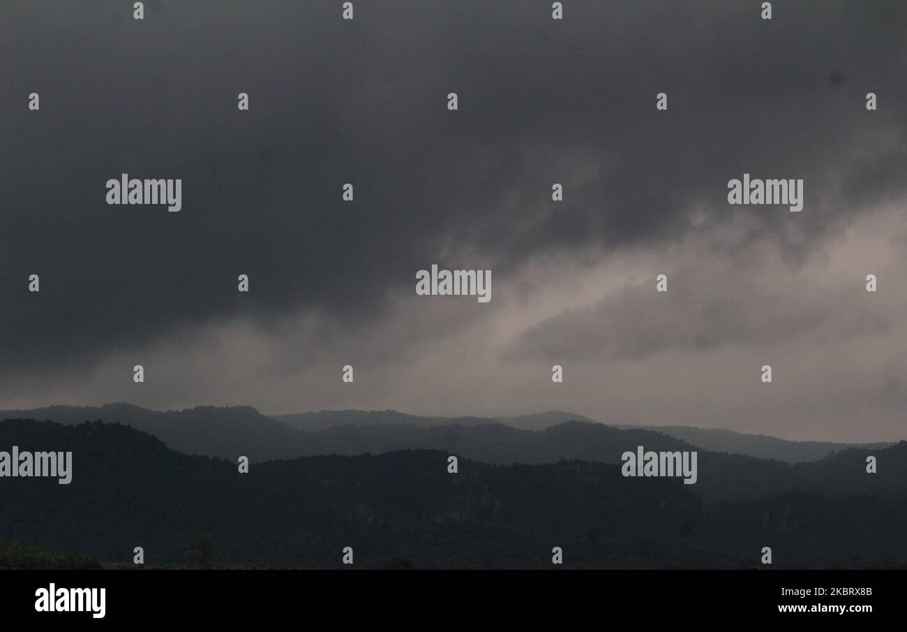 Rain clouds are hovering over the hill before the downpour just ...