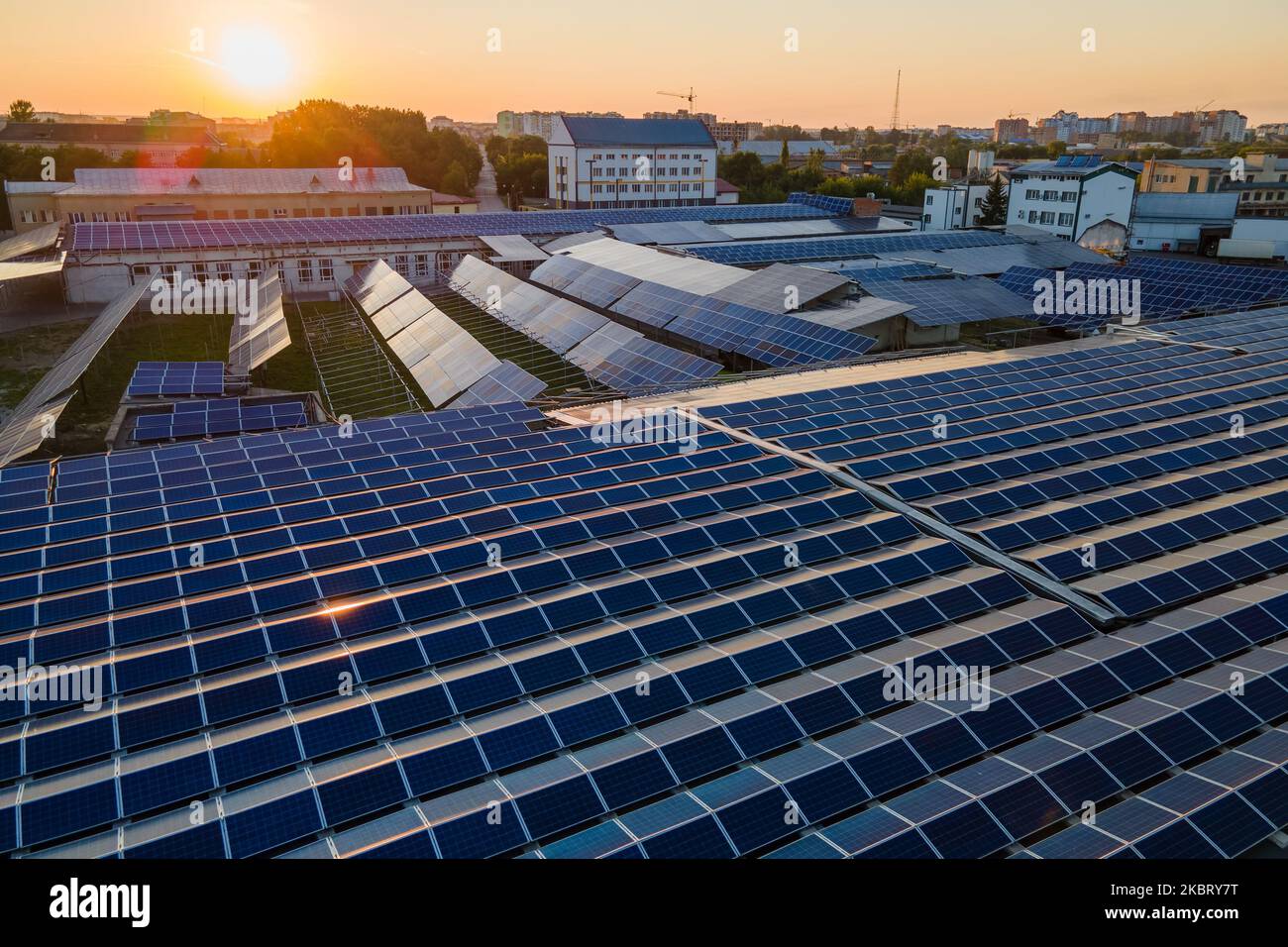 Aerial view of blue photovoltaic solar panels mounted on industrial ...