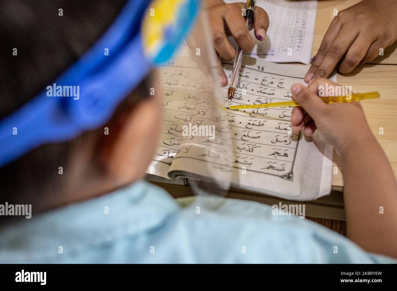 Face shield learning reading quran hi-res stock photography and images ...