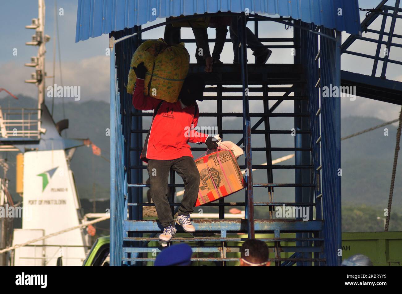 A number of KM Labobar passengers carrying luggage dropped off at the ...