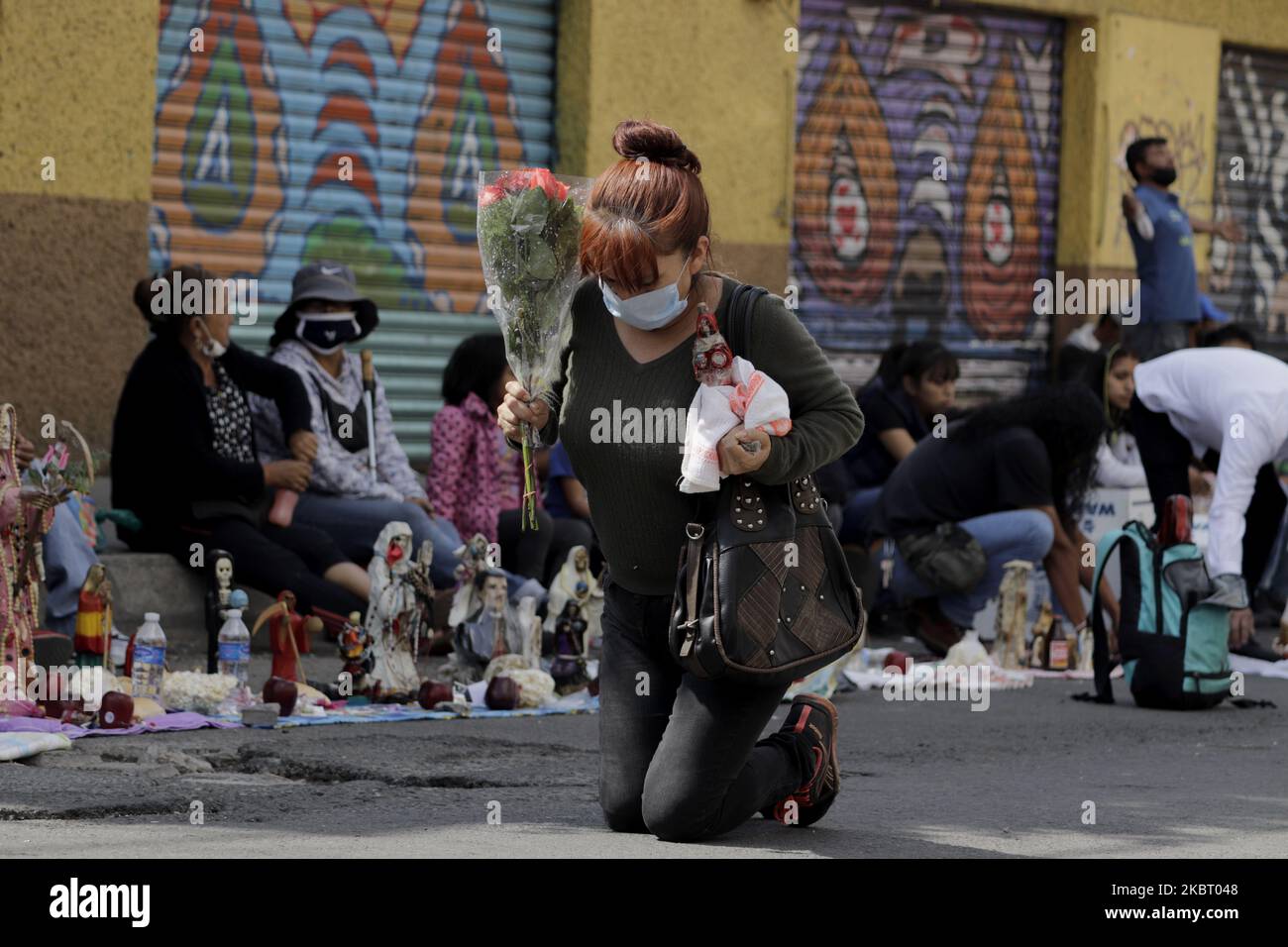 Believers of Santa Muerte, visit their temple on their knees located in ...