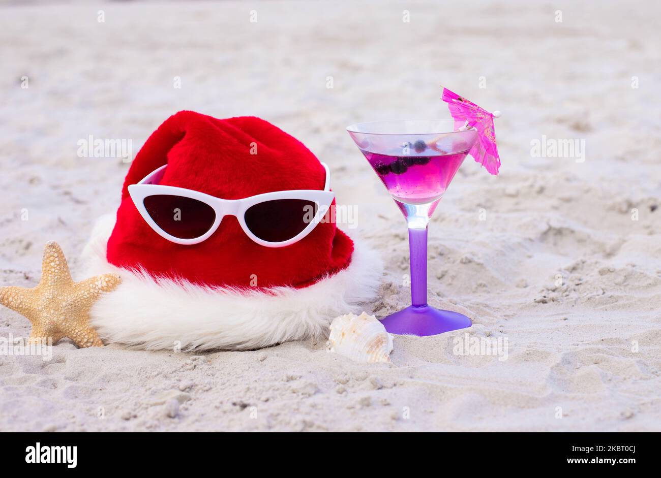 Santa Claus hat on the beach with starfish,cocktail and sunglases Stock ...