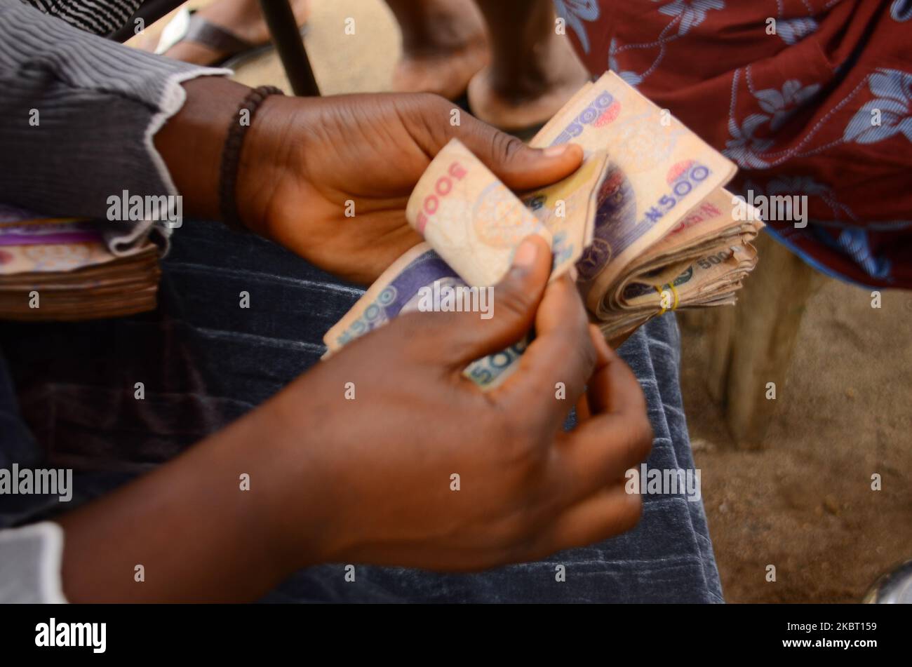 A traveller counting money a Nigerian currency (Naira) at the bus ...