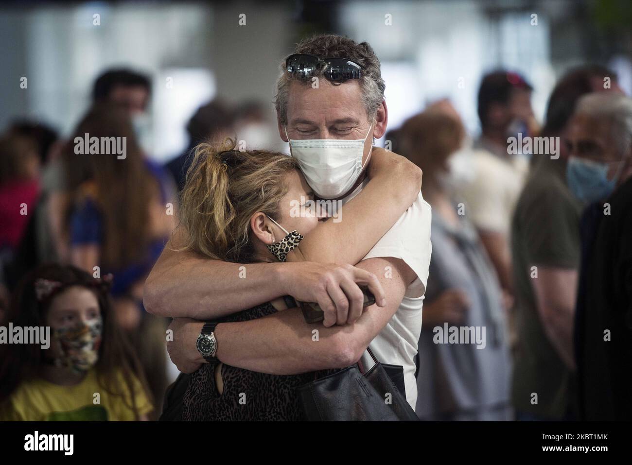 A couple hug when they meet after his arrival to Barcelona airport, on ...