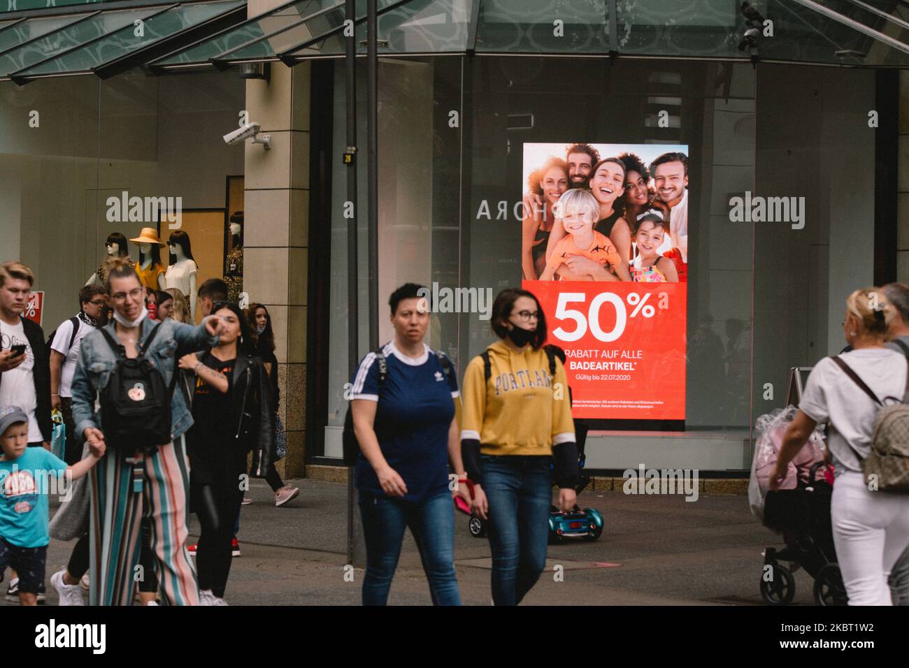 people walk past Sale sign posted in restail stores during the ...