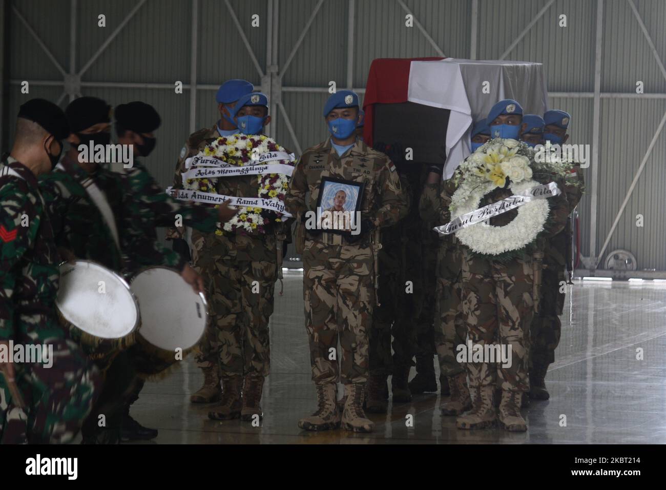 A military honor guard dressed in UN task force prepares to carry the ...