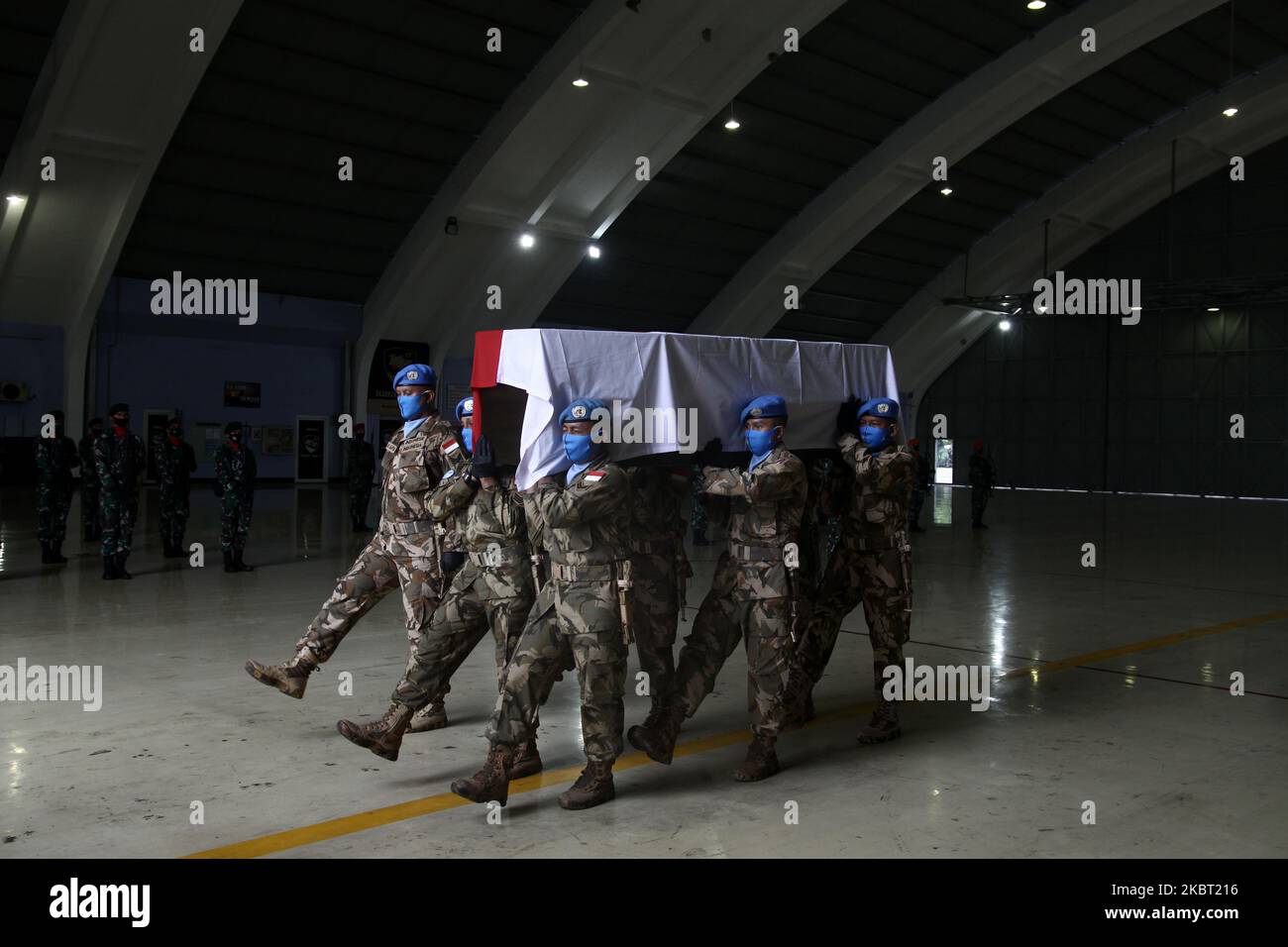 A military honor guard dressed in UN task force carry the casket of Sgt ...