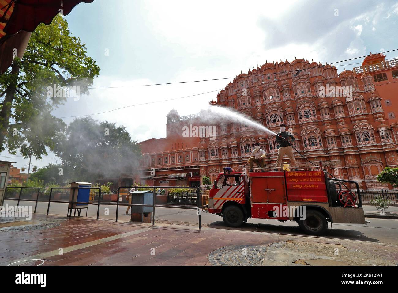 Fire fighters spray disinfectant in an area near Hawa Mahal during the ...