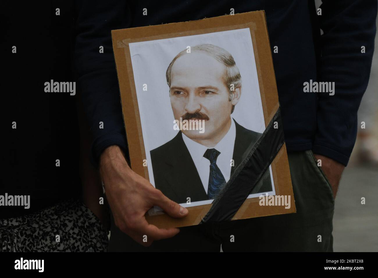 An activist holds a portrait of the President of Belarus, Alexander ...