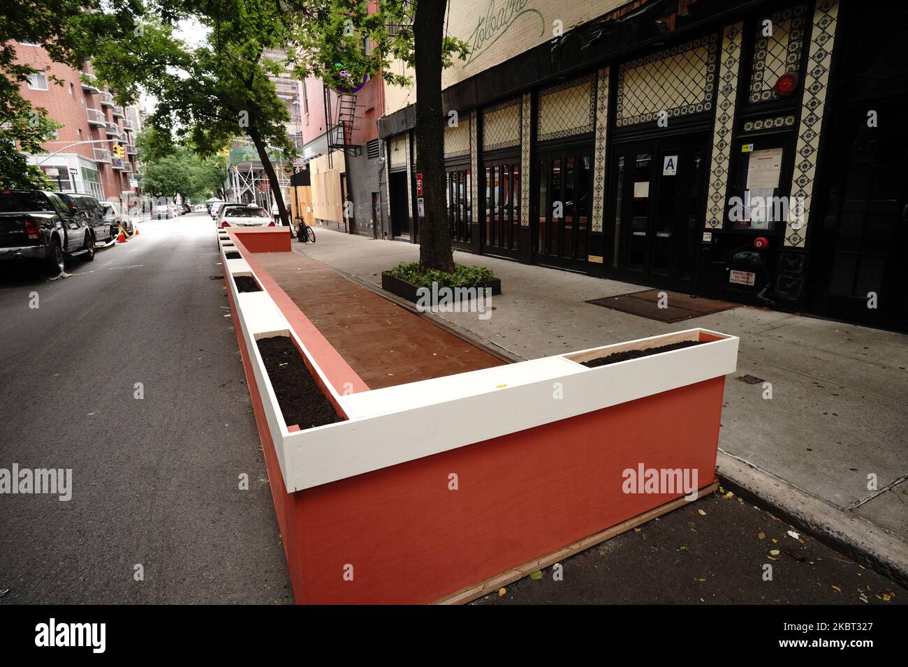 Carpenters are seen building dining kits outside a restaurant in New ...