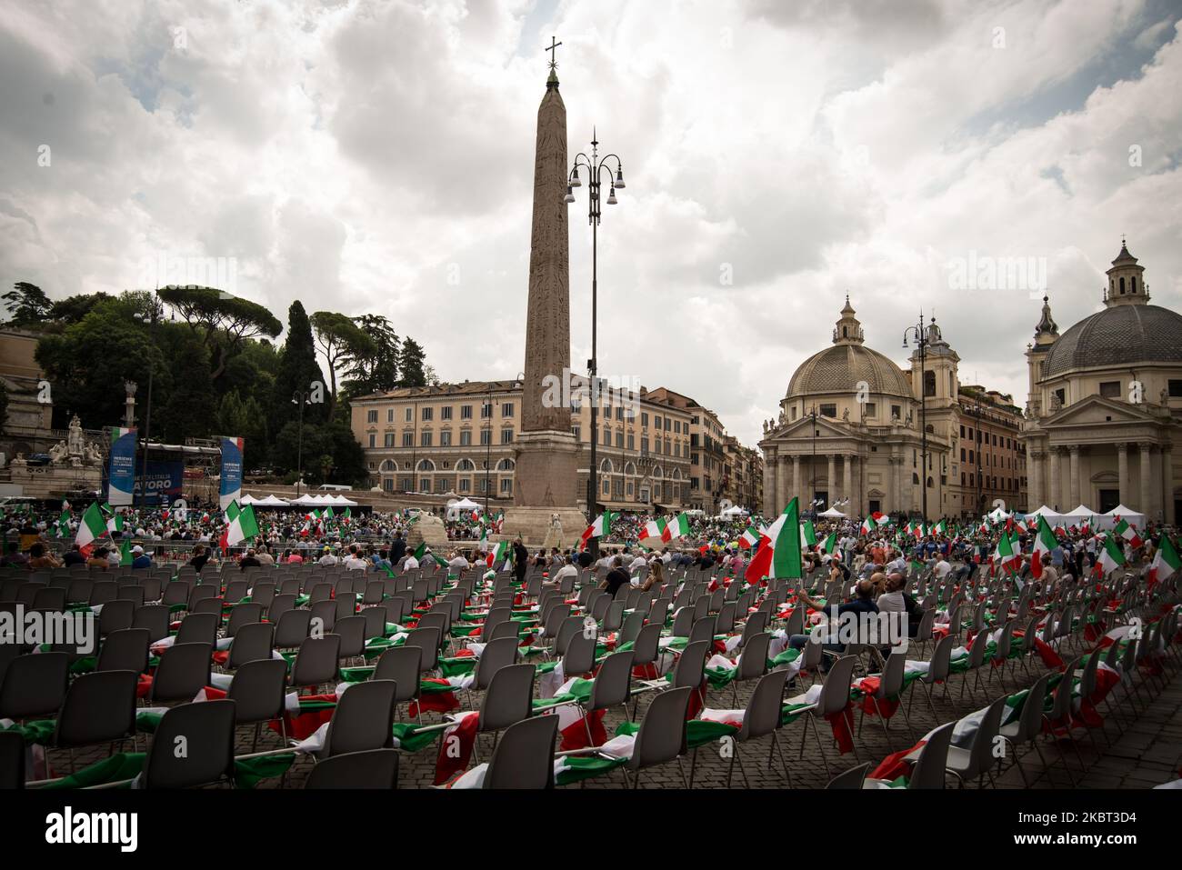 People brandish Italian national flags as they attend a joint rally ...