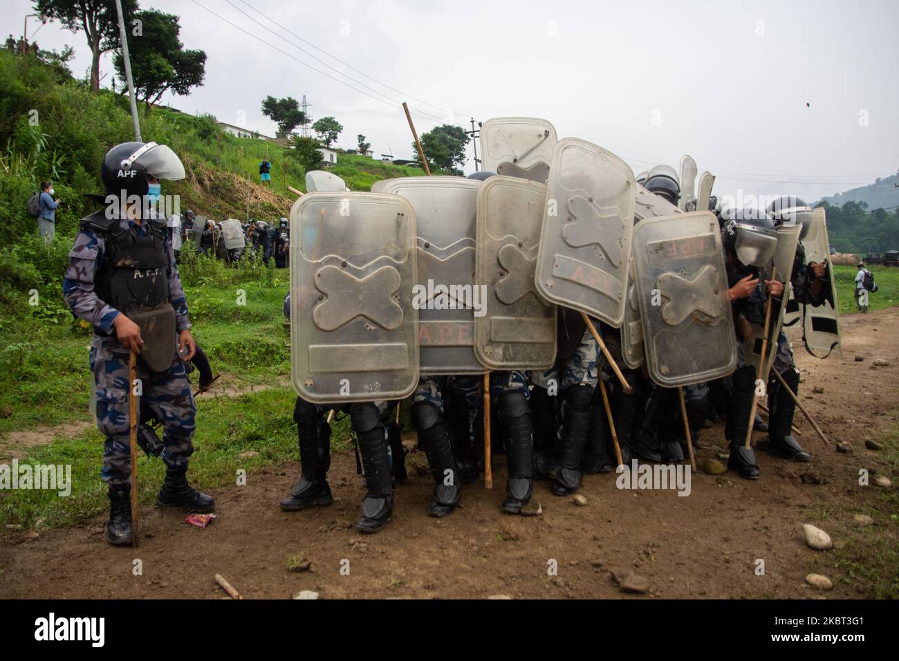 Nepalese policemen blocks the stone thrown at them by protestor during ...