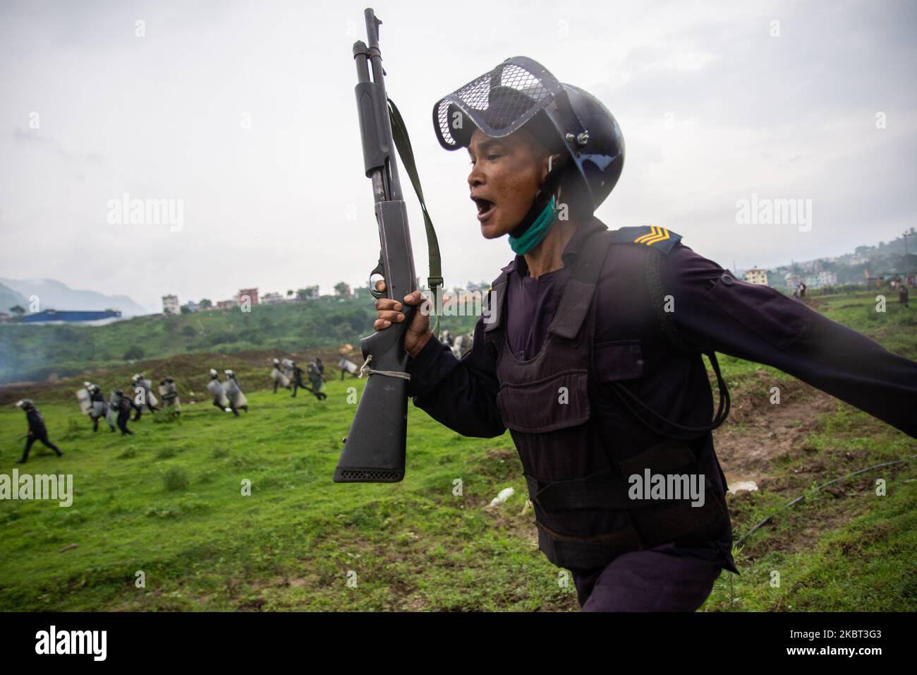Nepalese policemen disperse demonstrators during a protest that turned ...