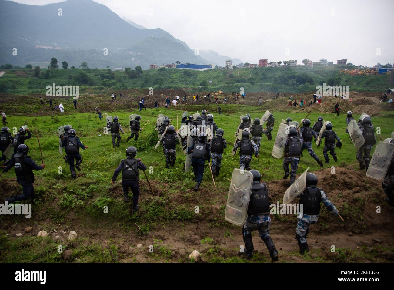 Nepalese policemen disperse demonstrators during a protest that turned ...
