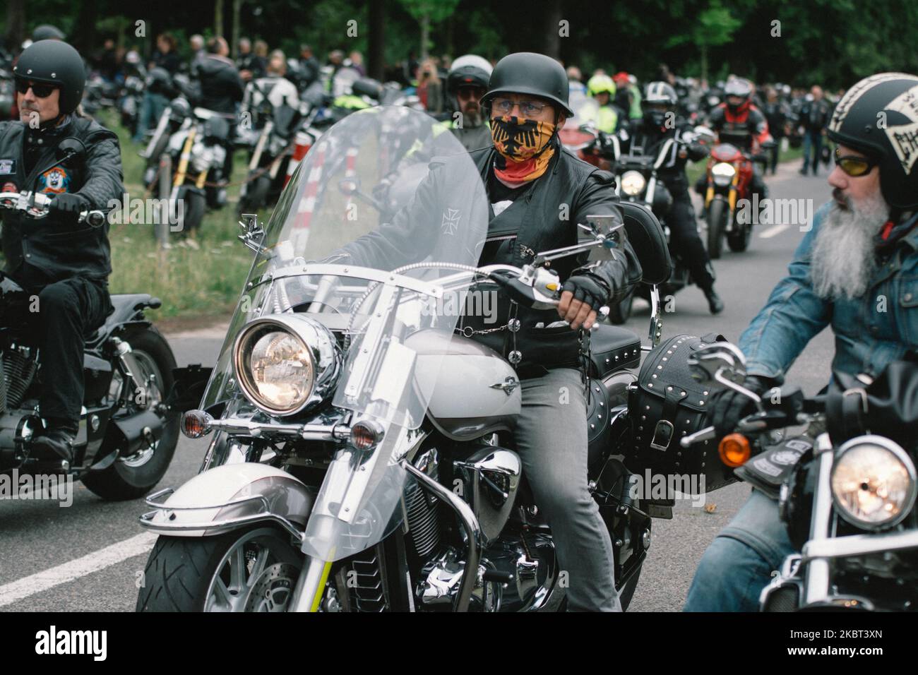 a biker with german flag mask is seen during the protest against ...