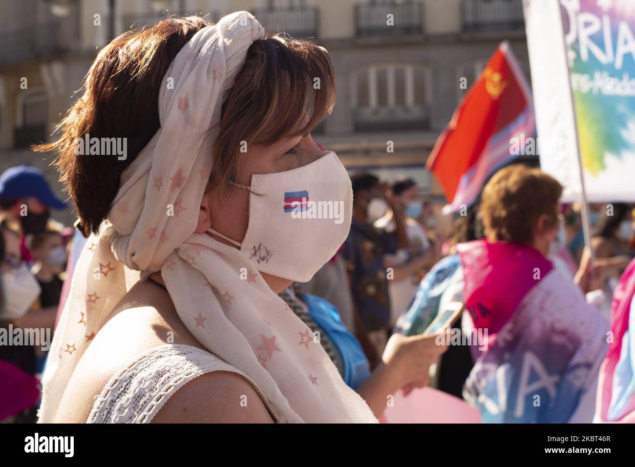 Protesters with face masks turned to Covid-10 wave trans flags during a ...