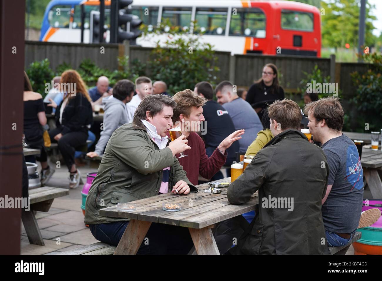 A group of lads enjoying their first pint as pub, bars and hairdressers ...