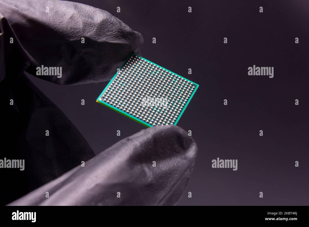 Semiconductor BGA chip in a hand on a black background Stock Photo - Alamy