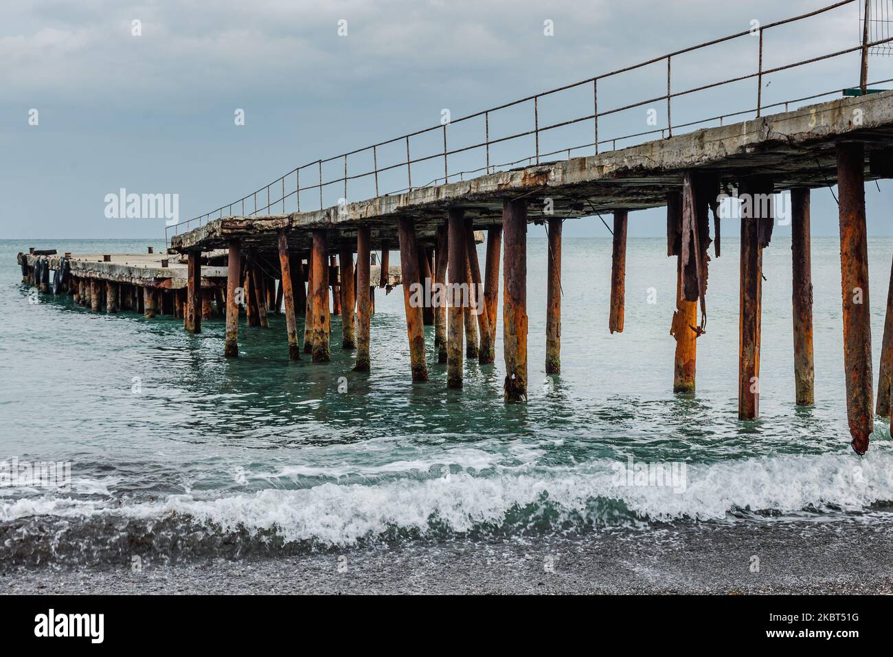 Old broken down pier on beach of Alushta. Crimea Stock Photo - Alamy