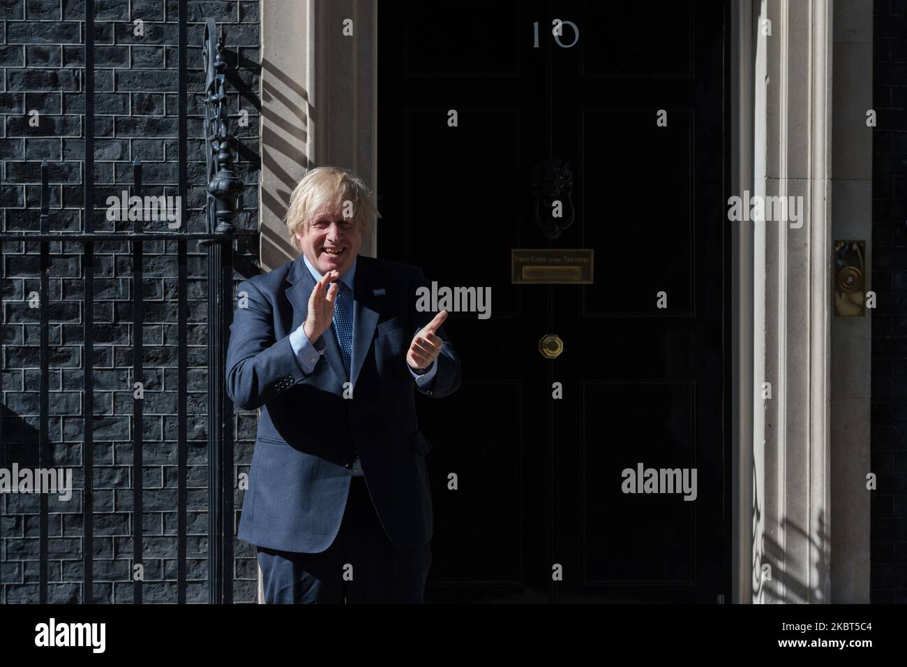 British Prime Minister Boris Johnson claps hands outside 10 Downing ...
