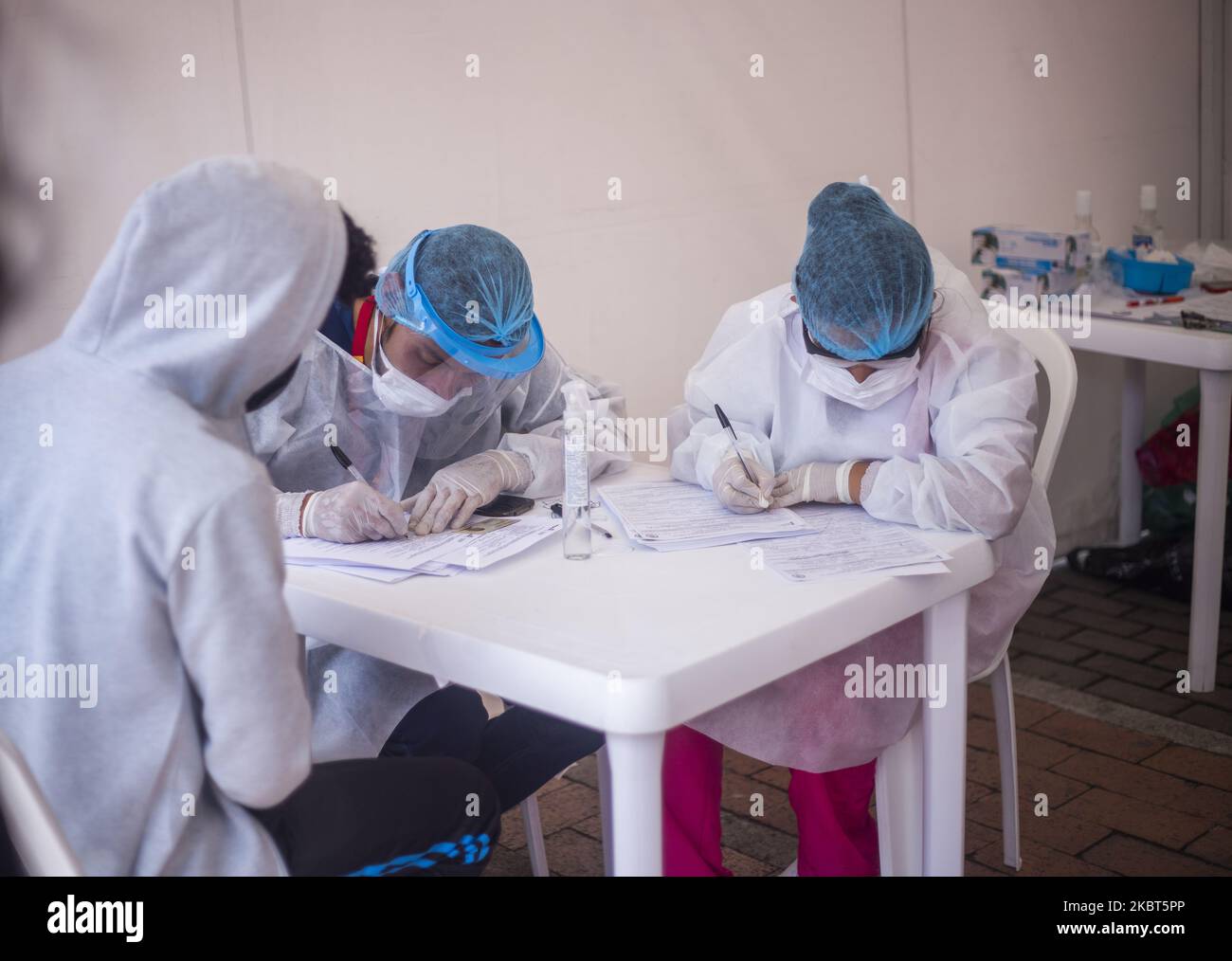 Health professionals take data from people before performing the covid ...