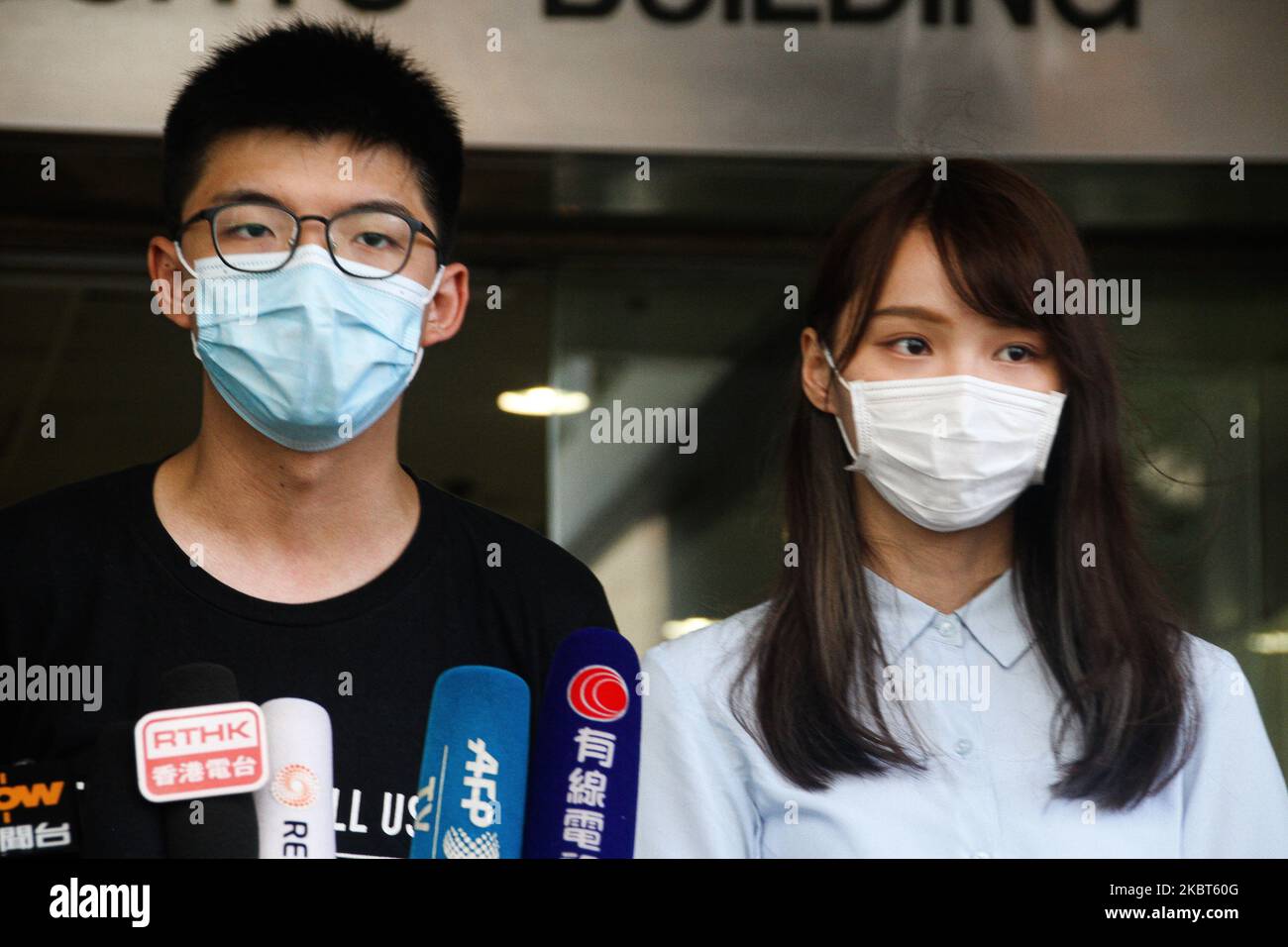 Joshua Wong and Agnes Chow speak to the press outside Eastern Court ...