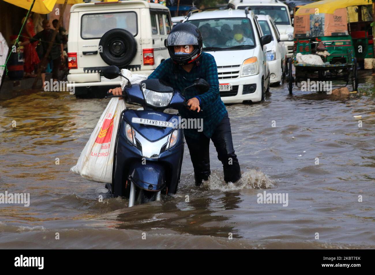 Commuters pass through rain water hi-res stock photography and images ...
