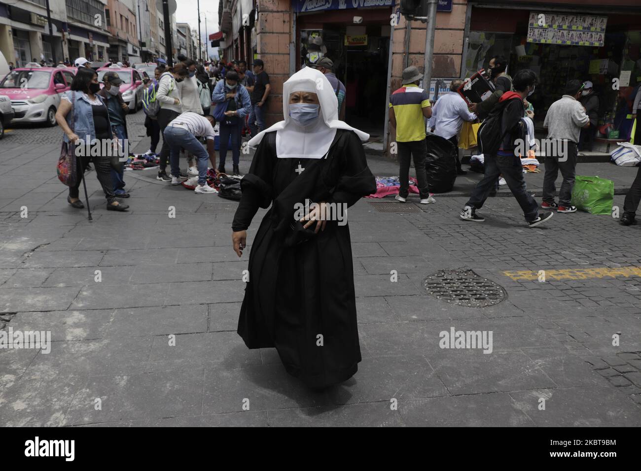 A nun crossing the street outside a store in Mexico City's Historic ...
