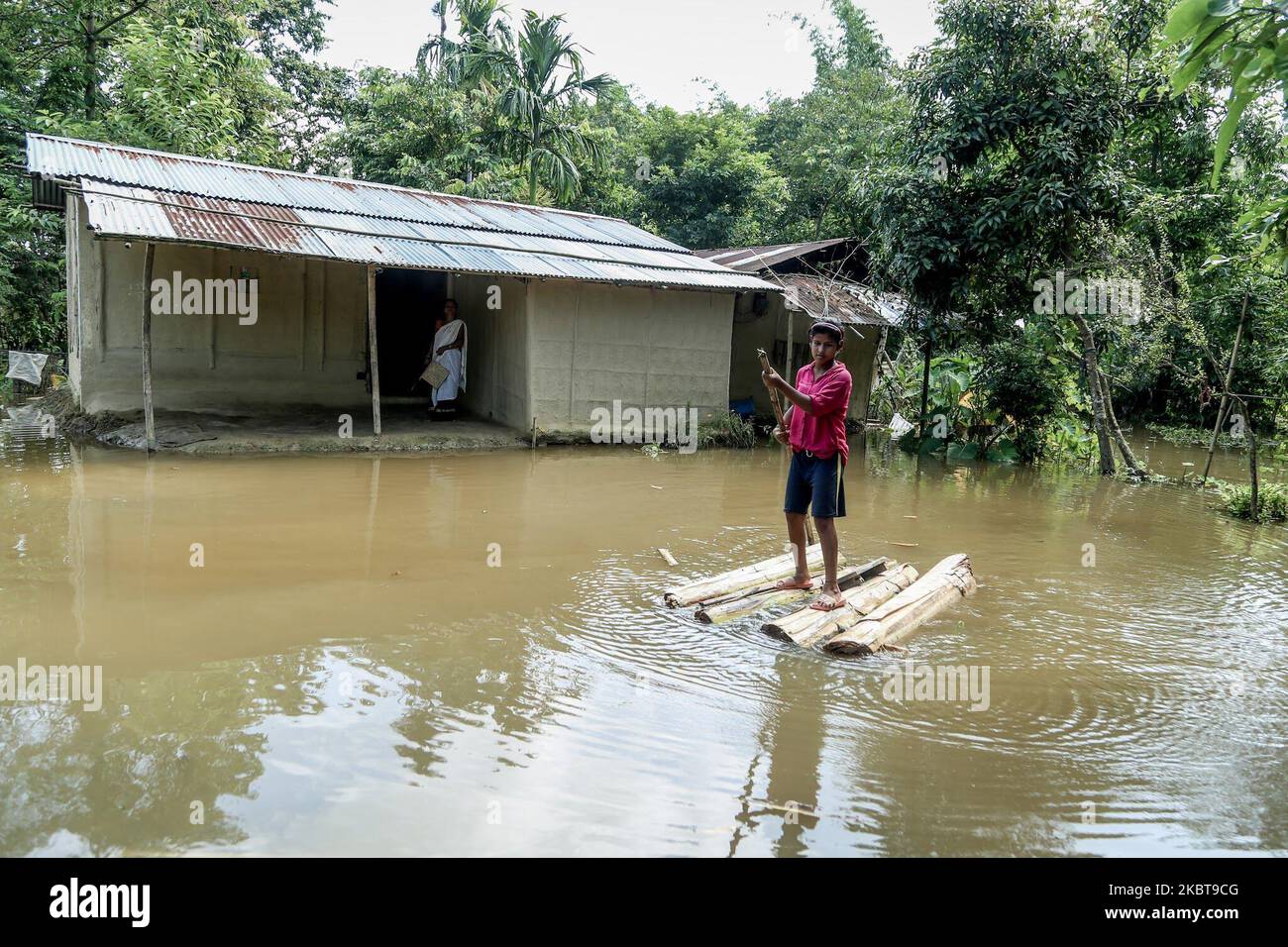 A girl sailing a banana tree boat at Demow village as flood entered ...