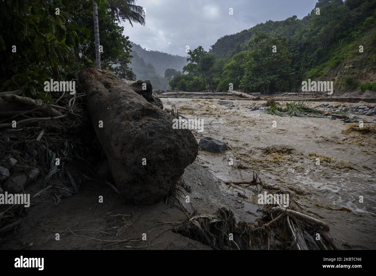 River water flow that carries mud and wood material after a flash flood ...