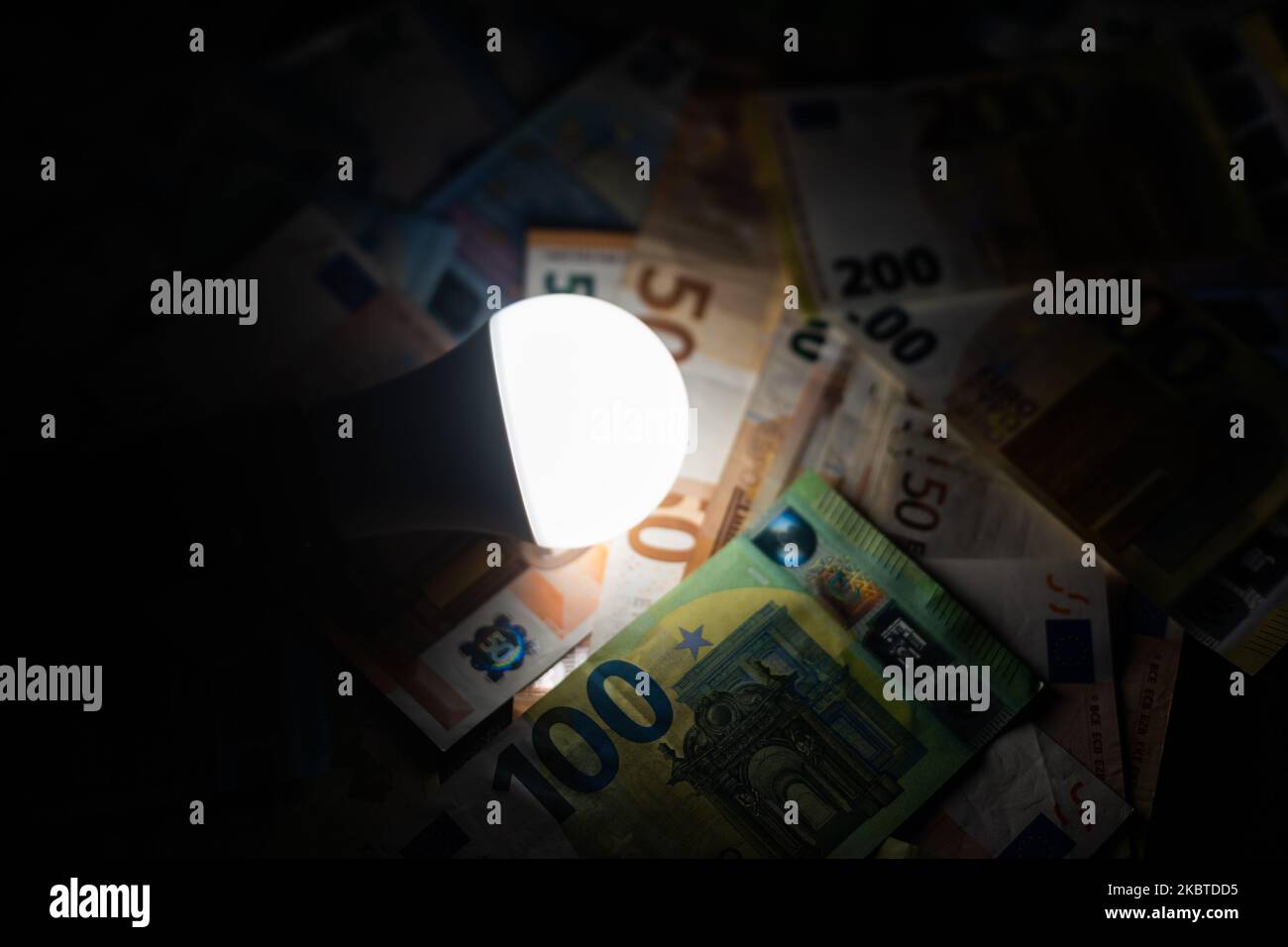 LED bulb on, with fluorescent bulb and incandescent bulb, with bills ...