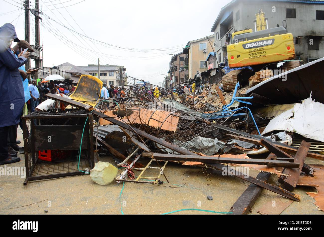 A digger clear the rubbles of the destroyed building, where three ...