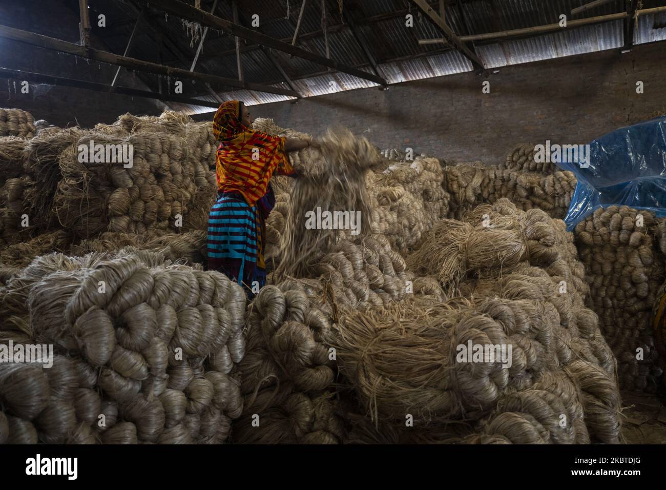 An women works at a jute processing factory in Narayanganj near Dhaka ...