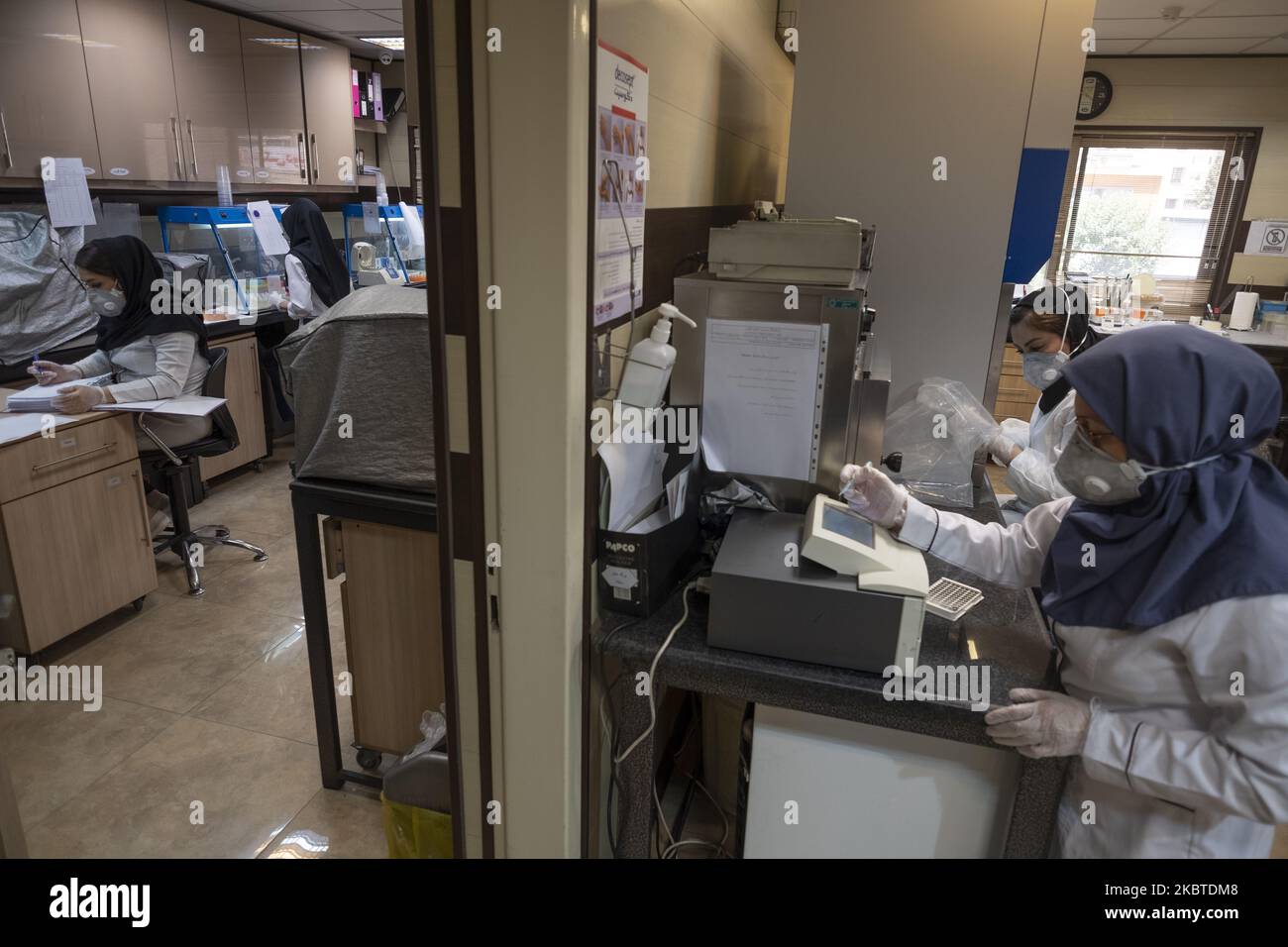 Laboratory technicians work in a virology laboratory in central Tehran ...