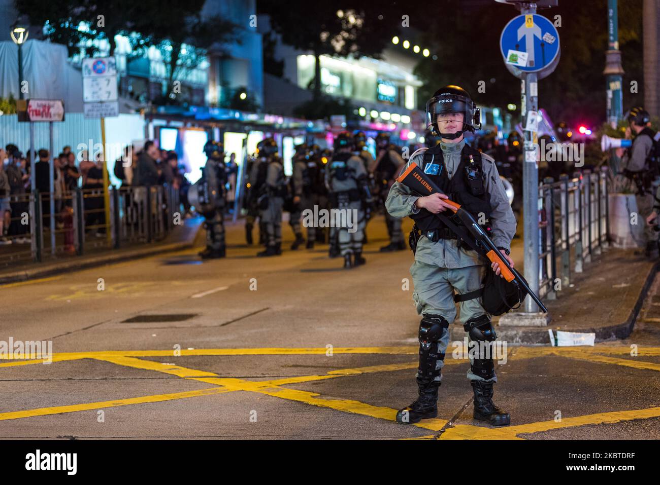 A policeman stands guard on Nathan road with a "less lethal" riot gun ...