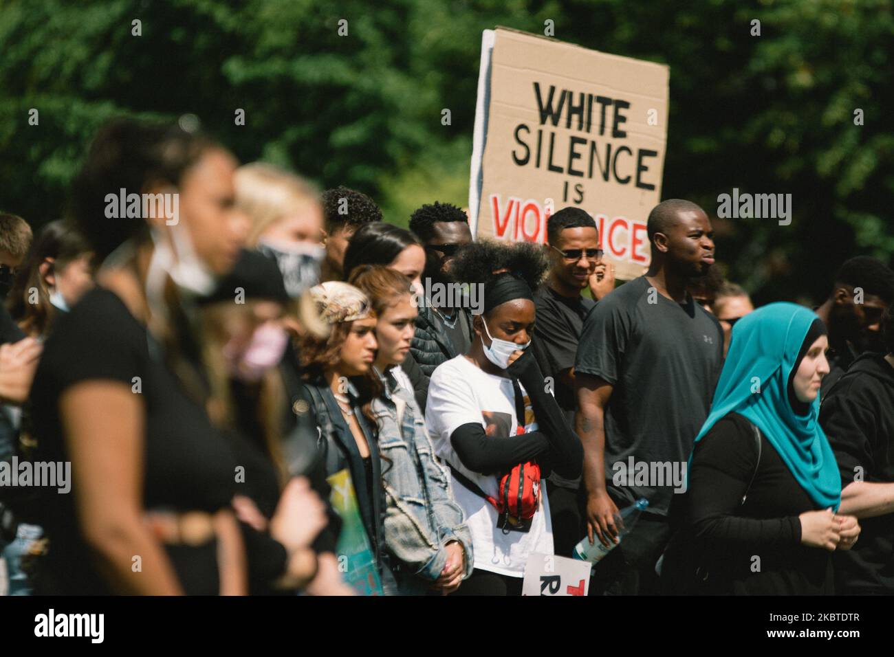 placard " white silence is violence" is seen during the protest against ...