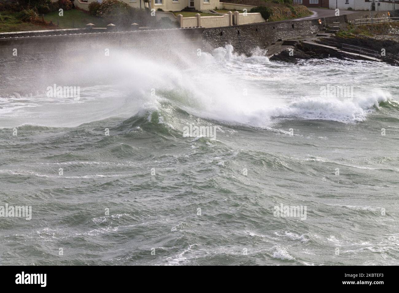 Storm surge waves breaking over the sea defences. Tragumna, West Cork ...