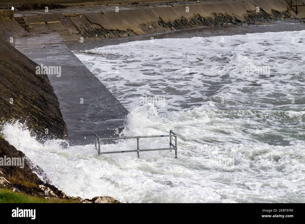 Storm surge waves breaking over the sea defences. Tragumna, West Cork ...