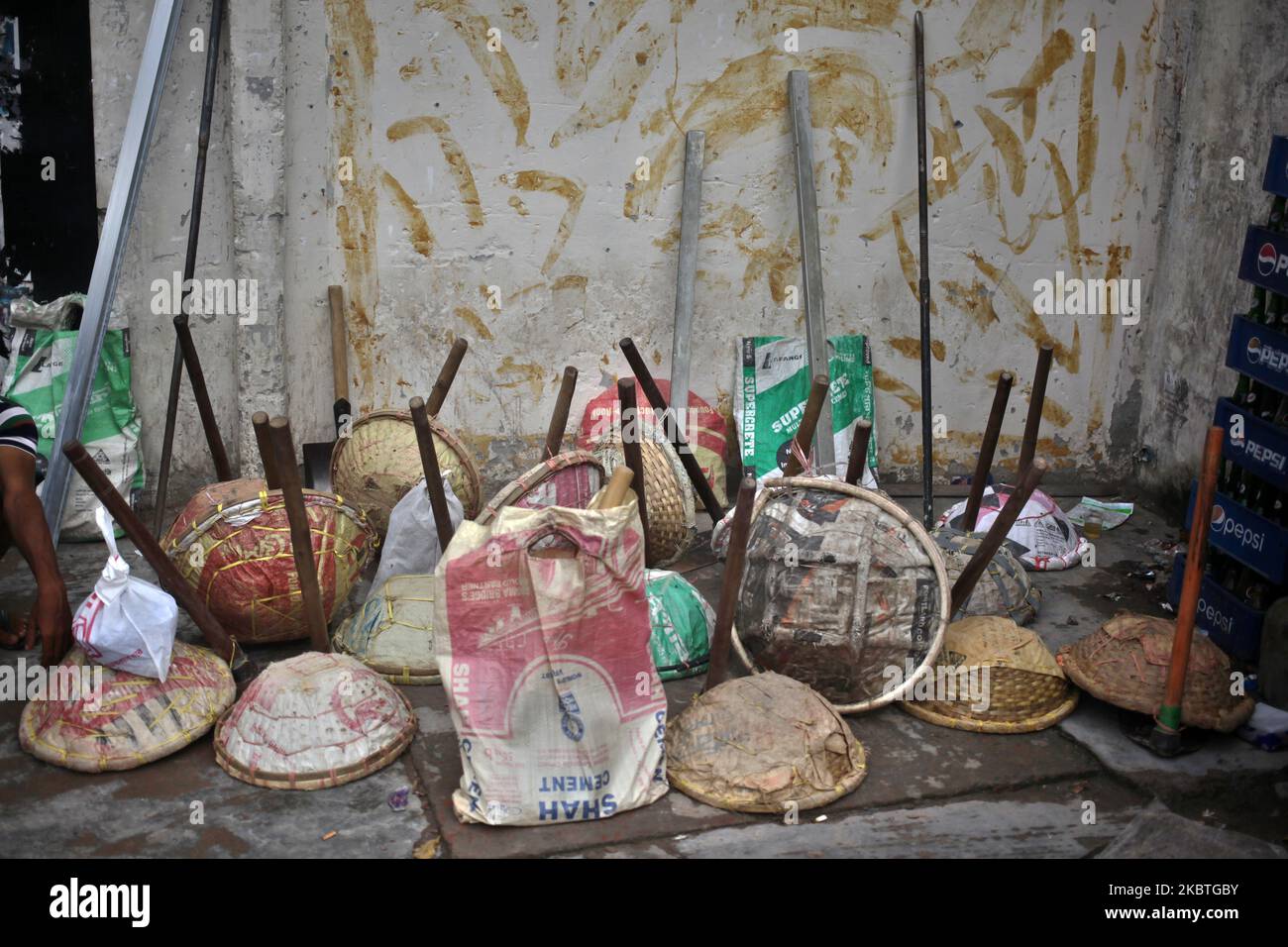 Equipment of day labourers is seen kept beside a street as they wait ...