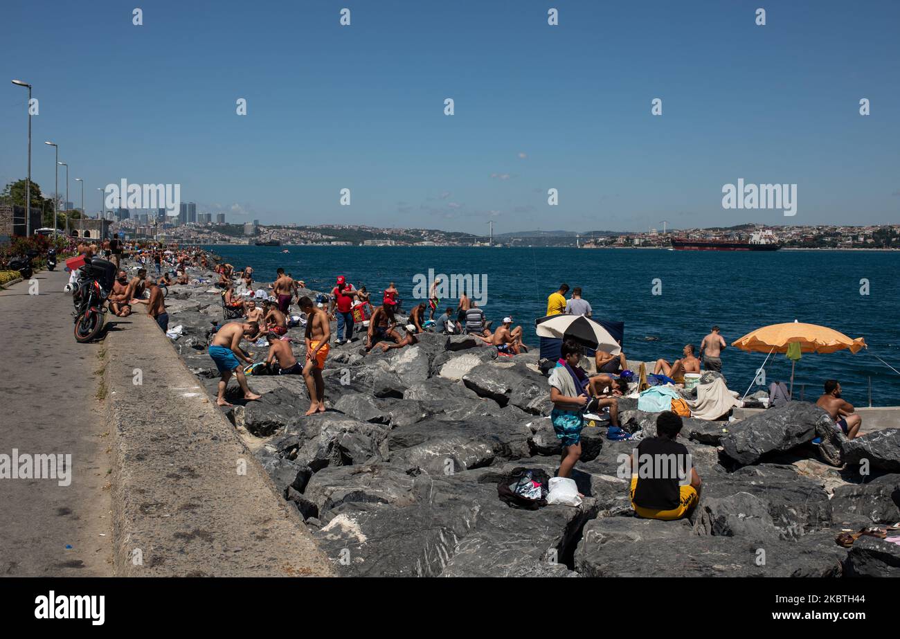 People enjoying the sun by the Marmara Sea near the historical ...