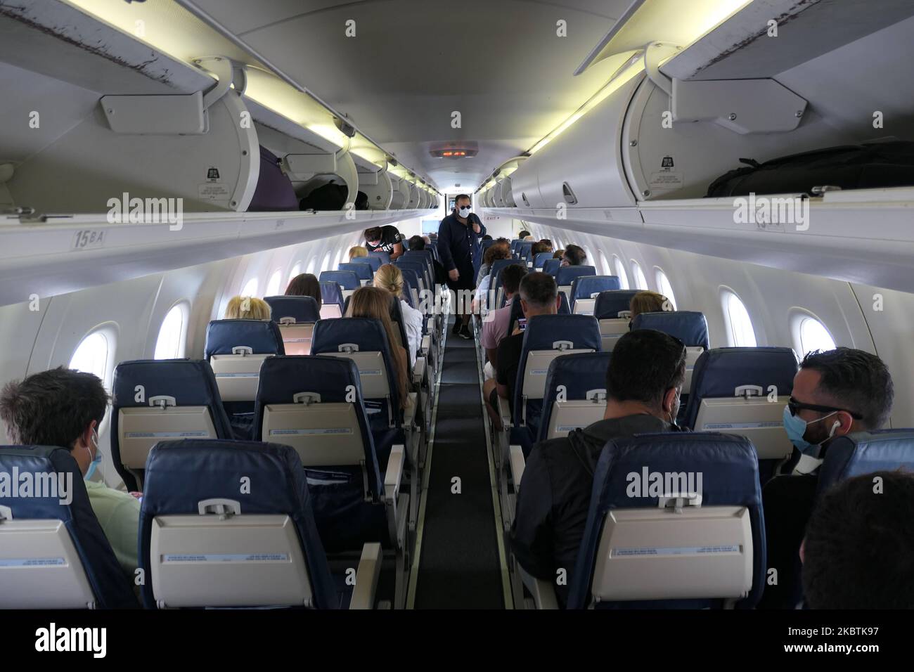 Passenger boarding in the cabin with obligatory the usage of facemasks ...