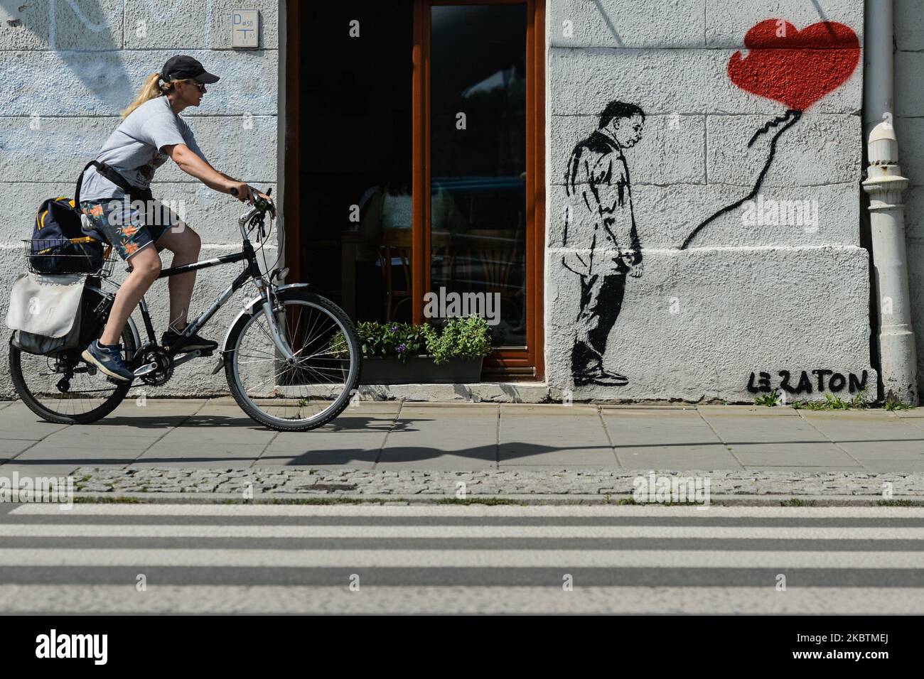 A lady cycles by a new mural with an image of the leader of the ruling ...